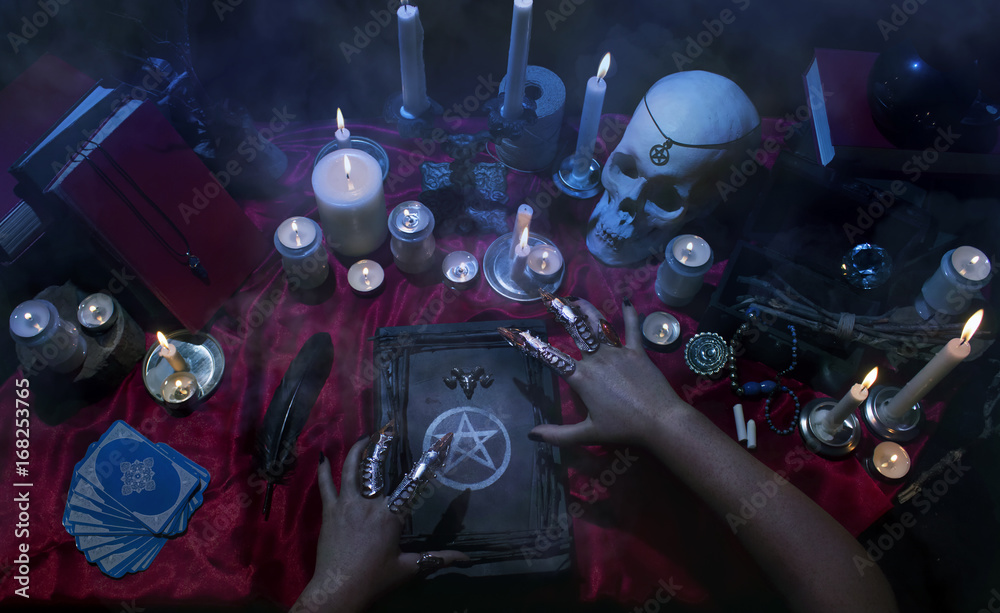 Witchcraft composition with witch's hands, satanic magic books, skull ...
