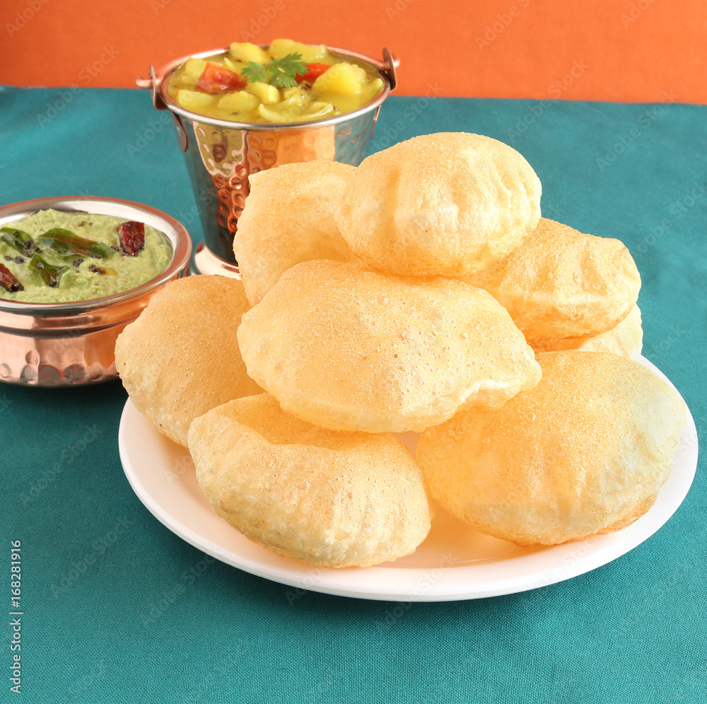 Stack of pooris, also known as Indian fried bread, are a traditional ...
