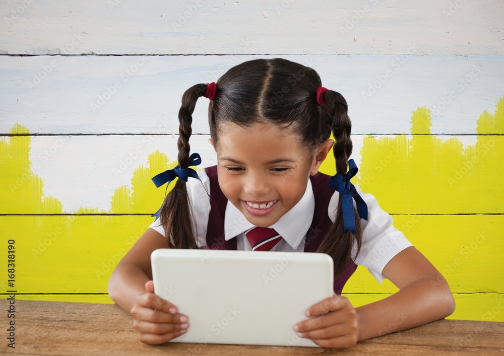 Girl on tablet in front yellow painted background Stock Photo | Adobe Stock