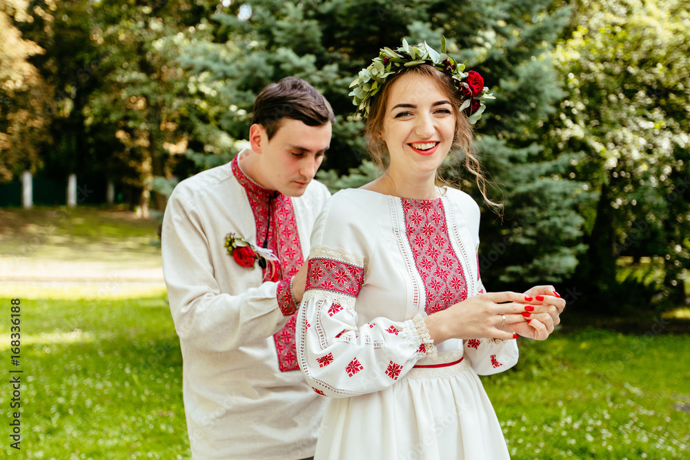 Beautiful happy young bride and groom in traditional clothes get ...