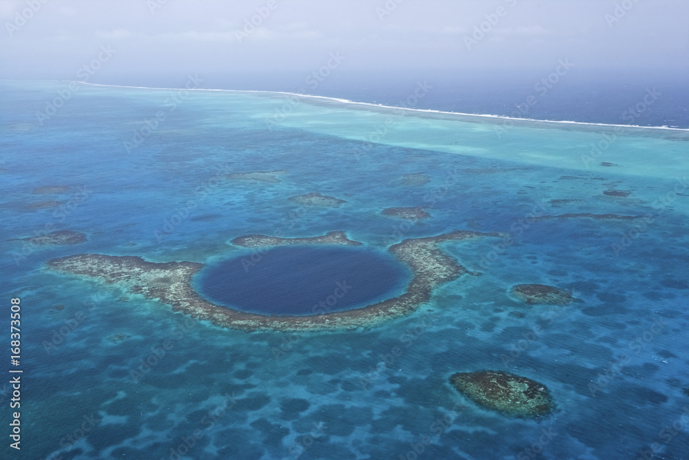 Aerial view of coral reefs and the Blue Hole, Lighthouse Atoll, Belize ...