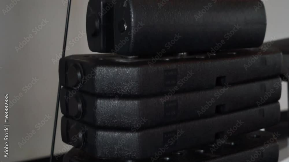 plates weighs stack moves, lifts, rises and pulls up in fitness gym ...