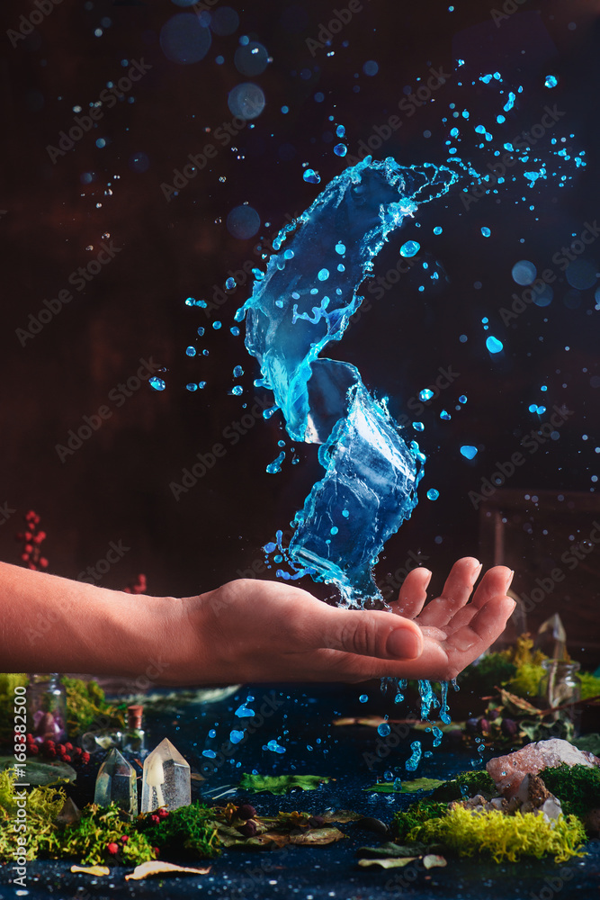 Wizard holding a moving spiral of clear water on their hand. Dark still ...