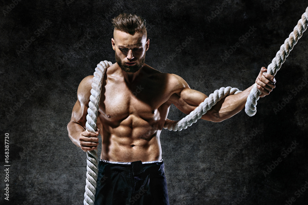 Handsome man with rope. Photo of young man with muscular topless body ...