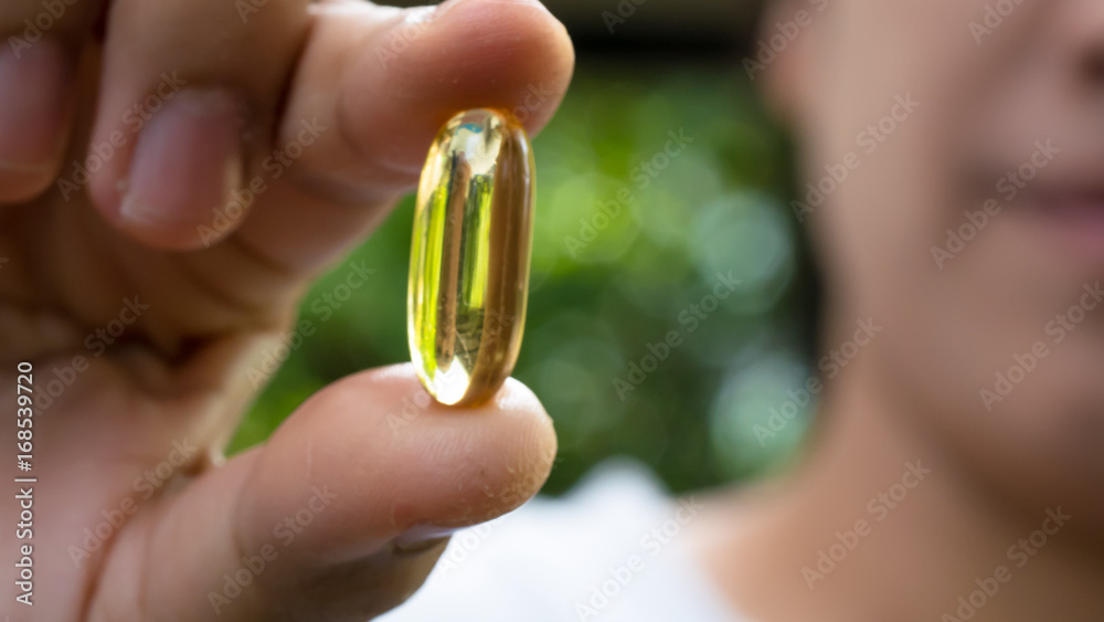 Women eating fish oil Stock Photo | Adobe Stock