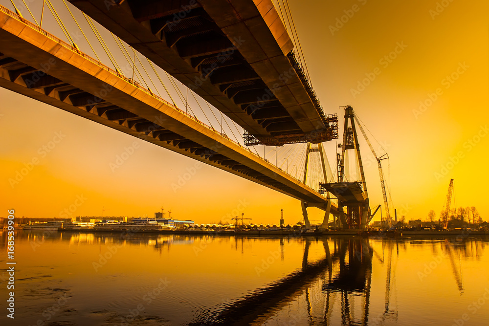 Construction of a cable-stayed bridge across the river. Construction of ...