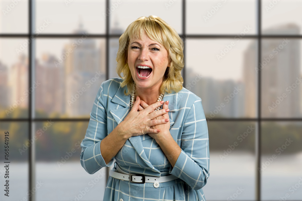 Portrait Of Laughing Mature Woman Adult Lady Holding Hands On Chest