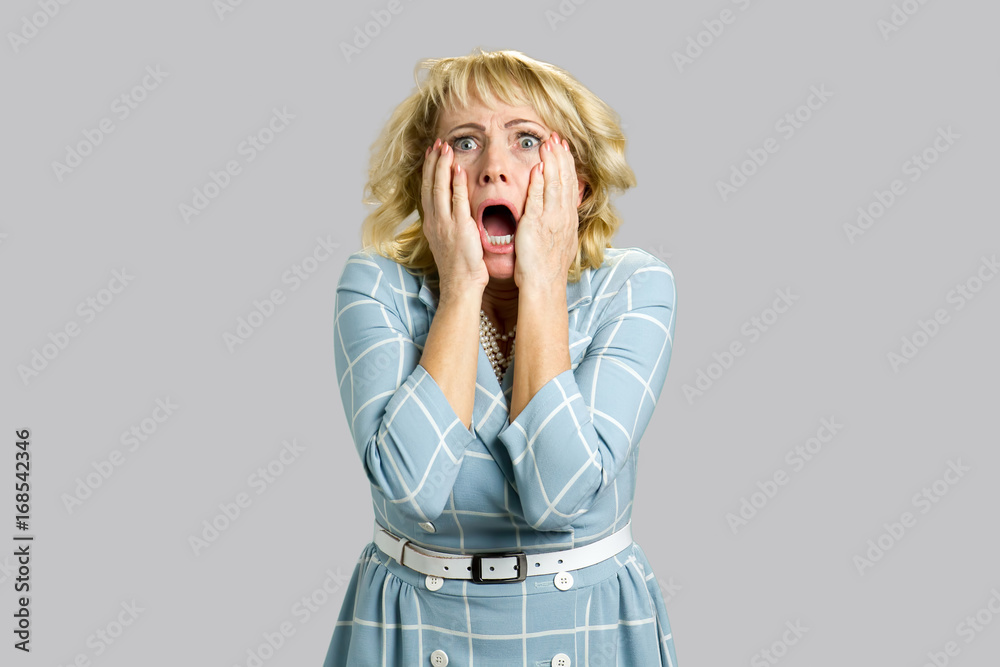 Portrait of shocked and stunned woman. Mature woman looking excited in ...