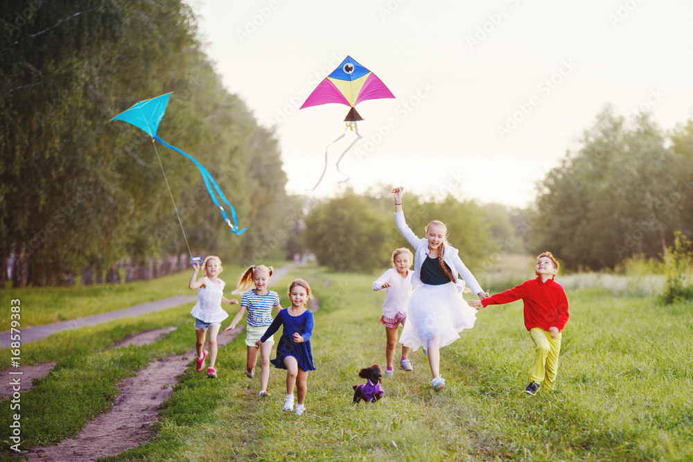 happy children in summer nature, flying a kite Stock Photo | Adobe Stock