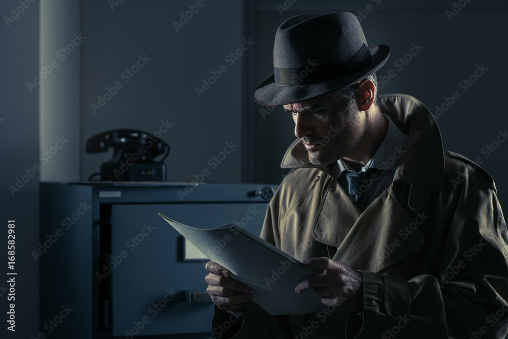 Undercover spy stealing files Stock Photo | Adobe Stock
