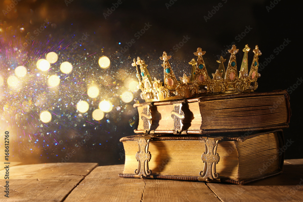 beautiful queen/king crown on old book. vintage filtered. fantasy ...