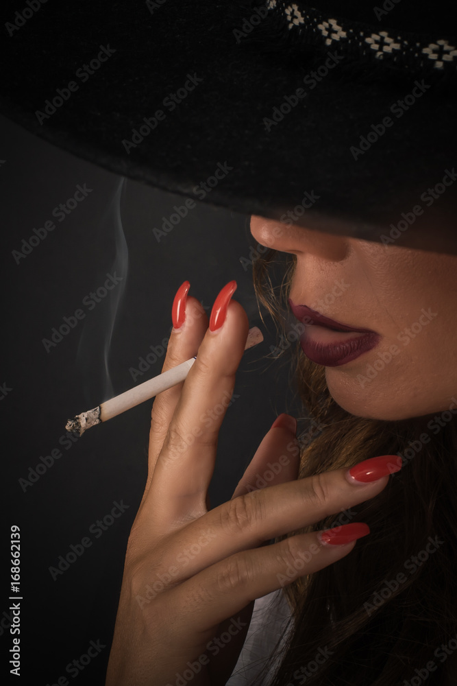 Portrait of sexy elegant lady woman with hat smoking cigarette Stock Photo | Adobe Stock