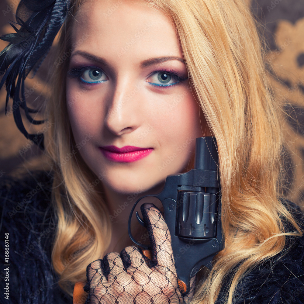 beautiful retro woman holding a revolver Stock Photo | Adobe Stock