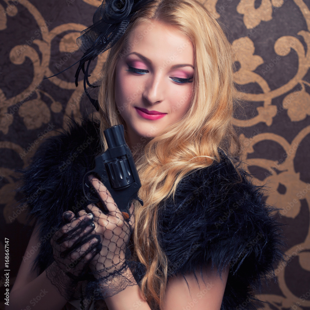 beautiful retro woman holding a revolver Stock Photo | Adobe Stock