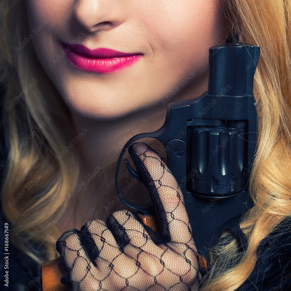 beautiful retro woman holding a revolver Stock Photo | Adobe Stock
