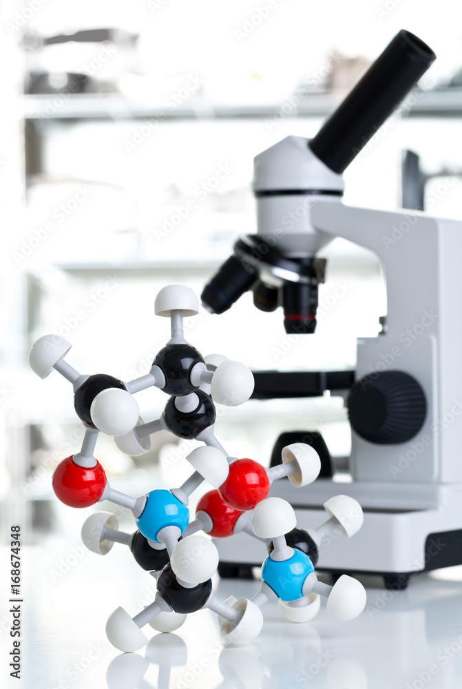 Microscope with molecule model in lab Stock Photo | Adobe Stock