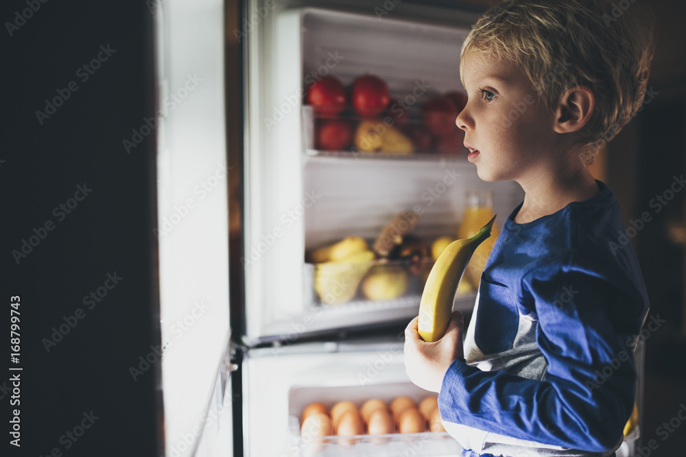 Boy Standing in Font of Open Fridge Stock Photo | Adobe Stock