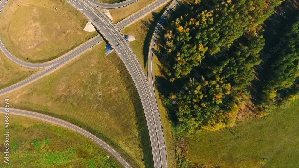 Road intersection. Aerial view of cars moving on highway road junction ...