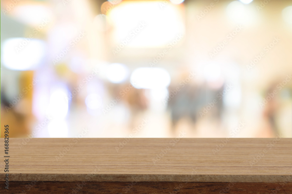 Perspective wooden table on top over blur coffee shop background, can ...