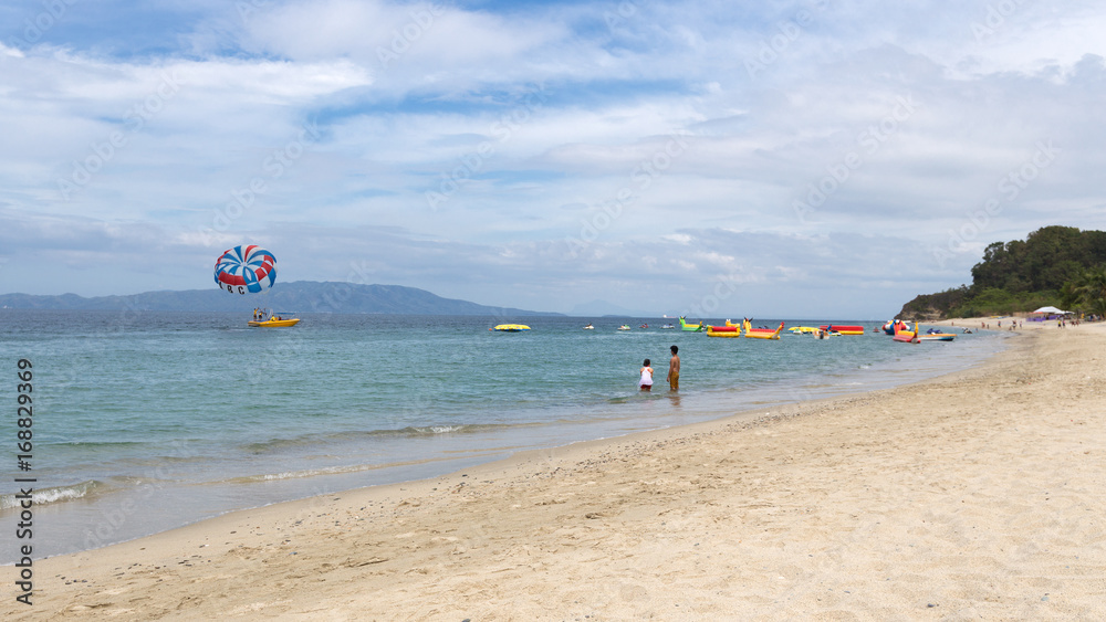 Seascape of beach with transparent sea, blue sky and boats.Taken at ...