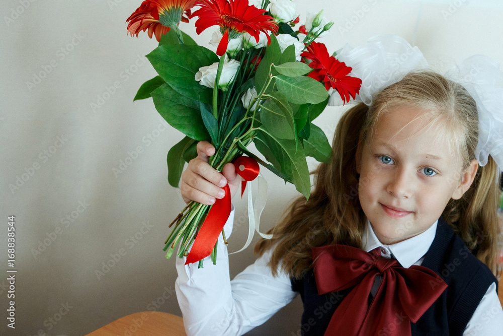 Beautiful elegant girl in a school uniform, a student of primary school ...