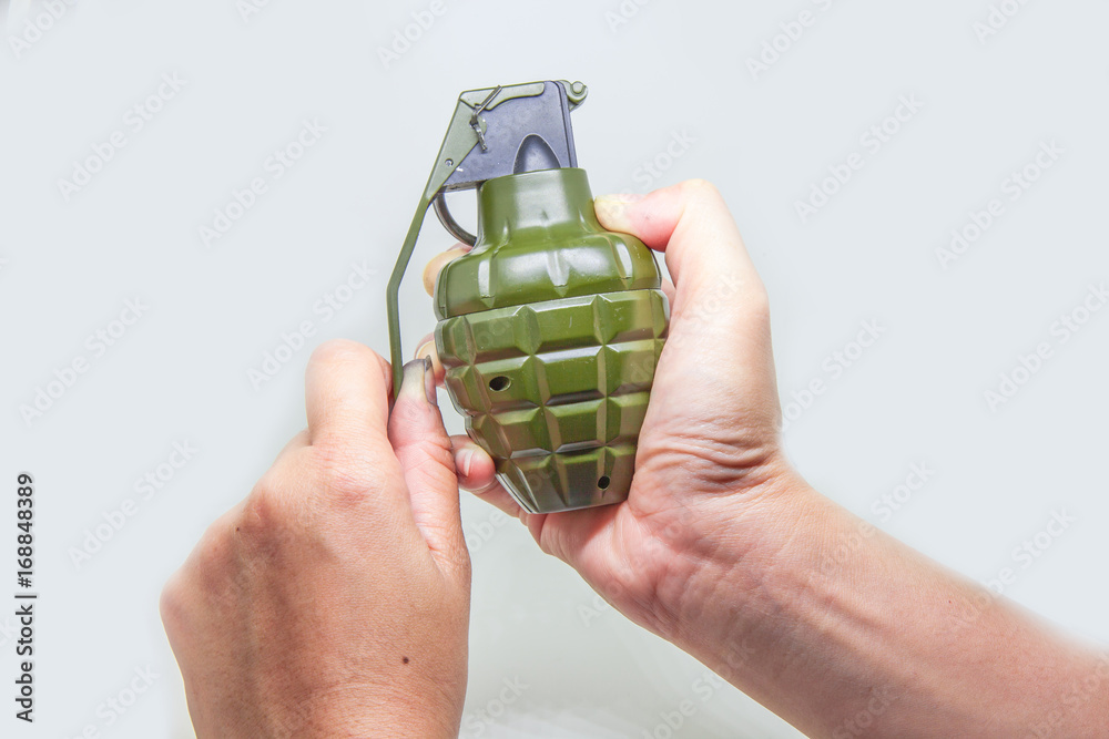 green metal hand grenade with round pin over When I pull out it will ...