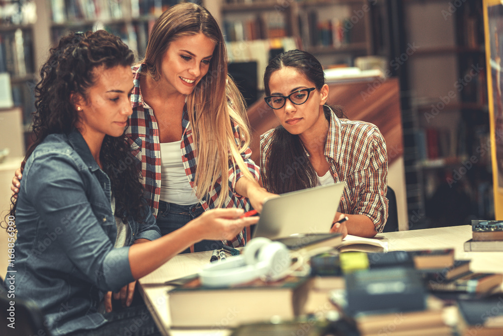 Group of female students study in the school library.Learning and ...