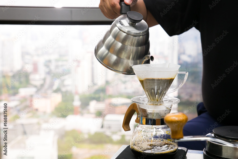 Hand drip coffee, Barista pouring water on coffee ground with filter in ...