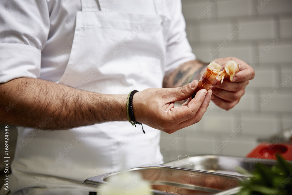 Chef Removing Prawn Head In Commercial Kitchen Stock Photo | Adobe Stock