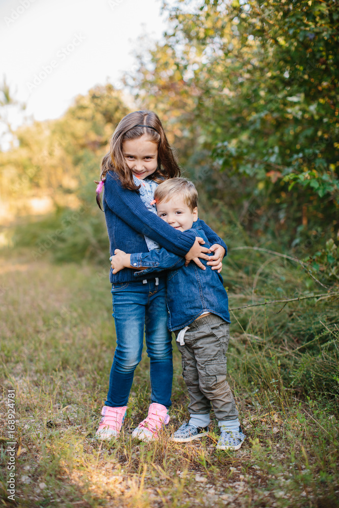 Beautiful brother and sister holding each other Stock Photo | Adobe Stock
