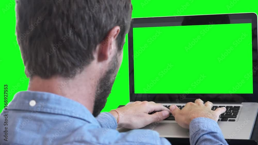 Man Typing On Green Screen Laptop. Man typing on a computer on a green ...