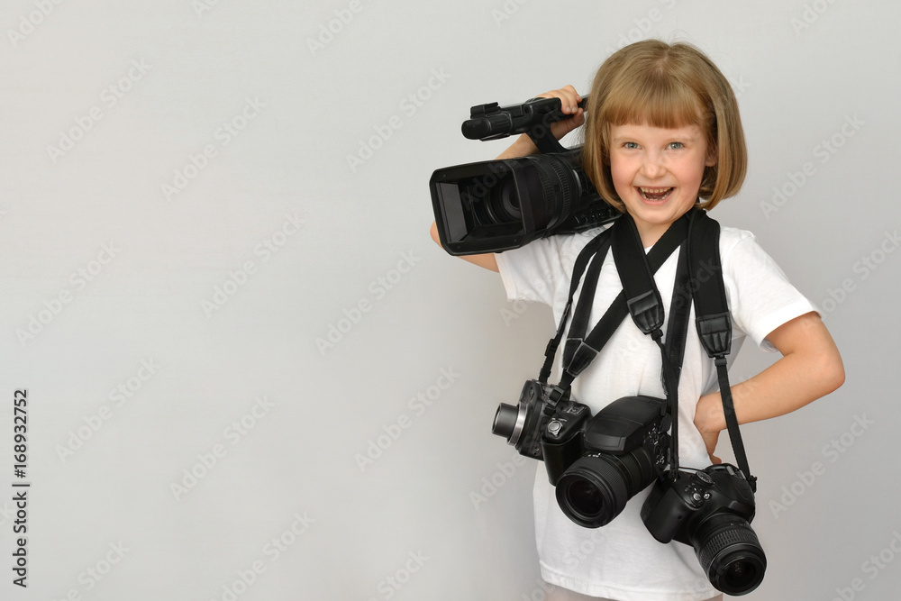 Cute little girl (child, kid,) with a camera and the camera is happy ...