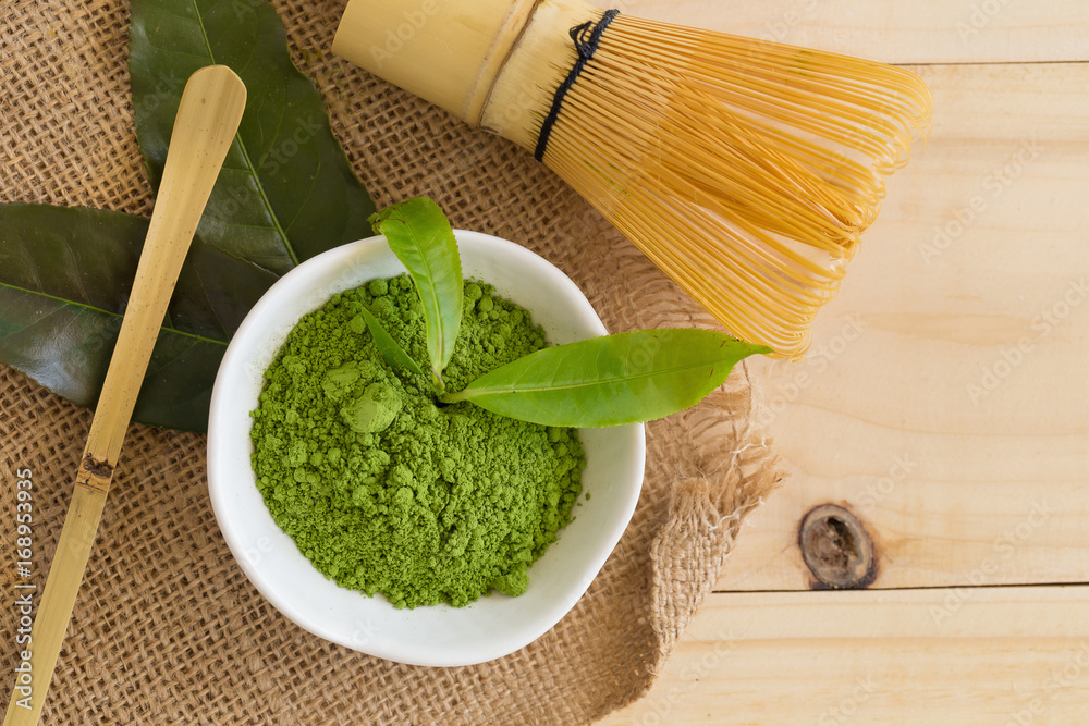 Set of matcha powder bowl, wooden spoon and whisk, green tea leaf ...