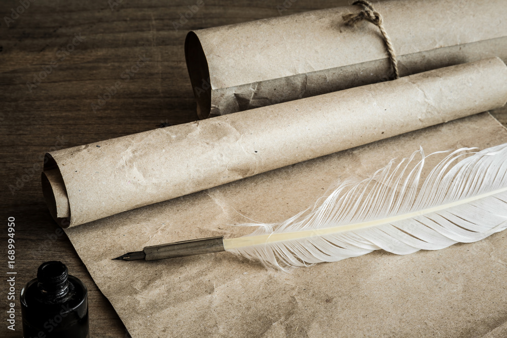 Old quill pen on the old paper. Letter writing. Historical atmosphere ...