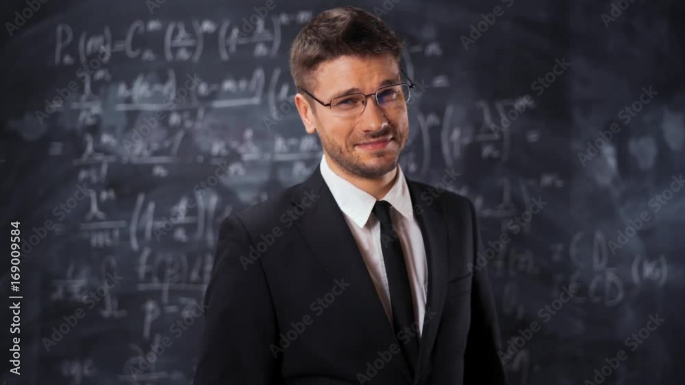 Portrait of scientist man with mathematical equations background. He ...