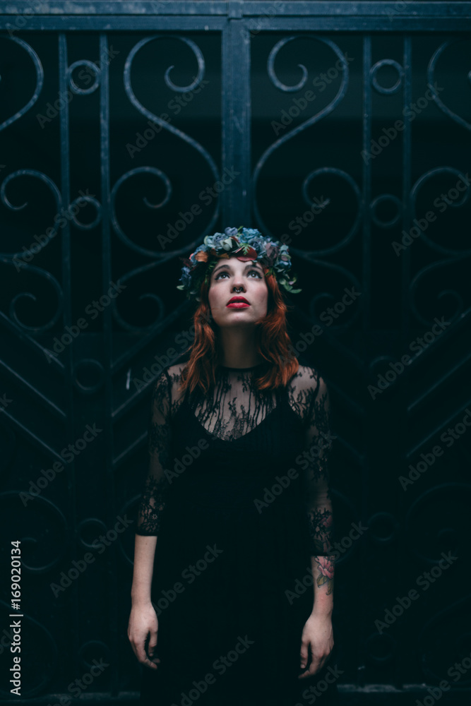 Woman wearing a flower crown and goth clothing Stock Photo | Adobe Stock