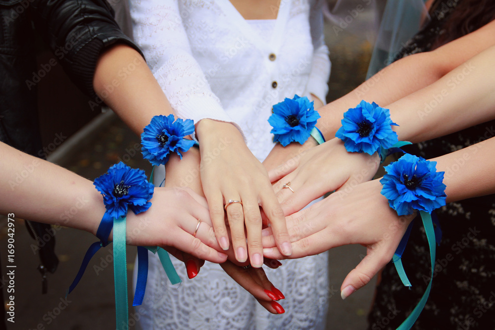 Hen-party before the wedding. Six female hands with blue flower ...