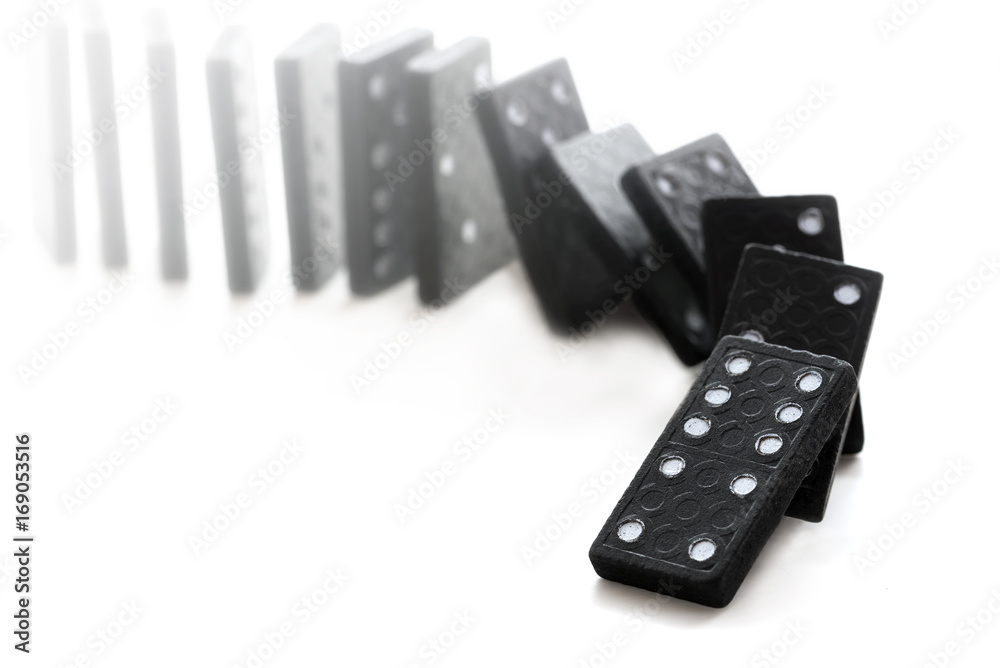 Domino effect with falling black dominoes on a white background ...
