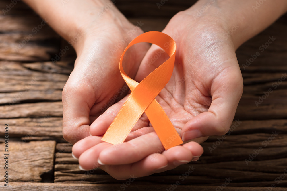 Human Hand Showing Orange Ribbon To Support Breast Cancer Cause Stock ...