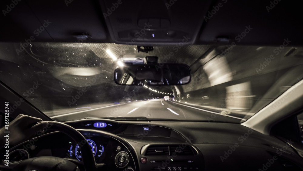 Cockpit view driving car inside a dark tunnel Stock Photo | Adobe Stock
