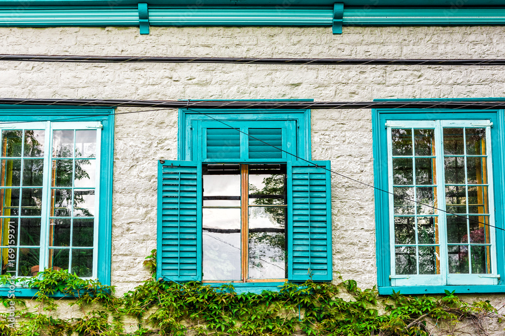 Blue decorated windows and brick stone wall architecture with cloudy ...