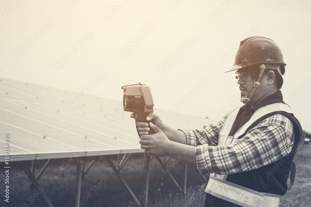engineer checking heat of solar panel and using ir camera to scan ...