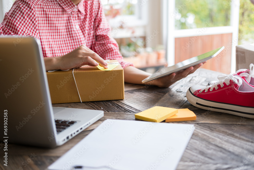 small business owner checking product order at workplace. freelance ...