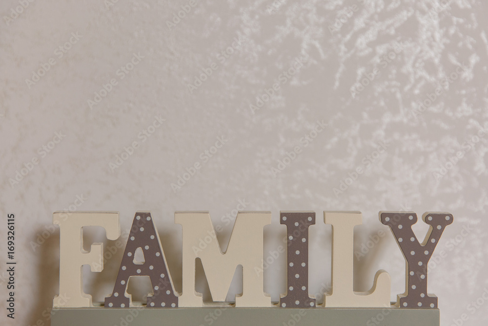 Family concept. Wooden letters ''Family'' with inscription ''Family is ...