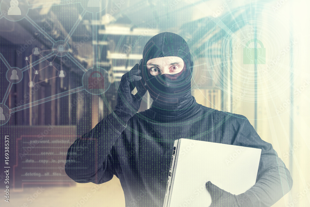 Hacker with laptop talking on the phone. Cyber attack and data security ...