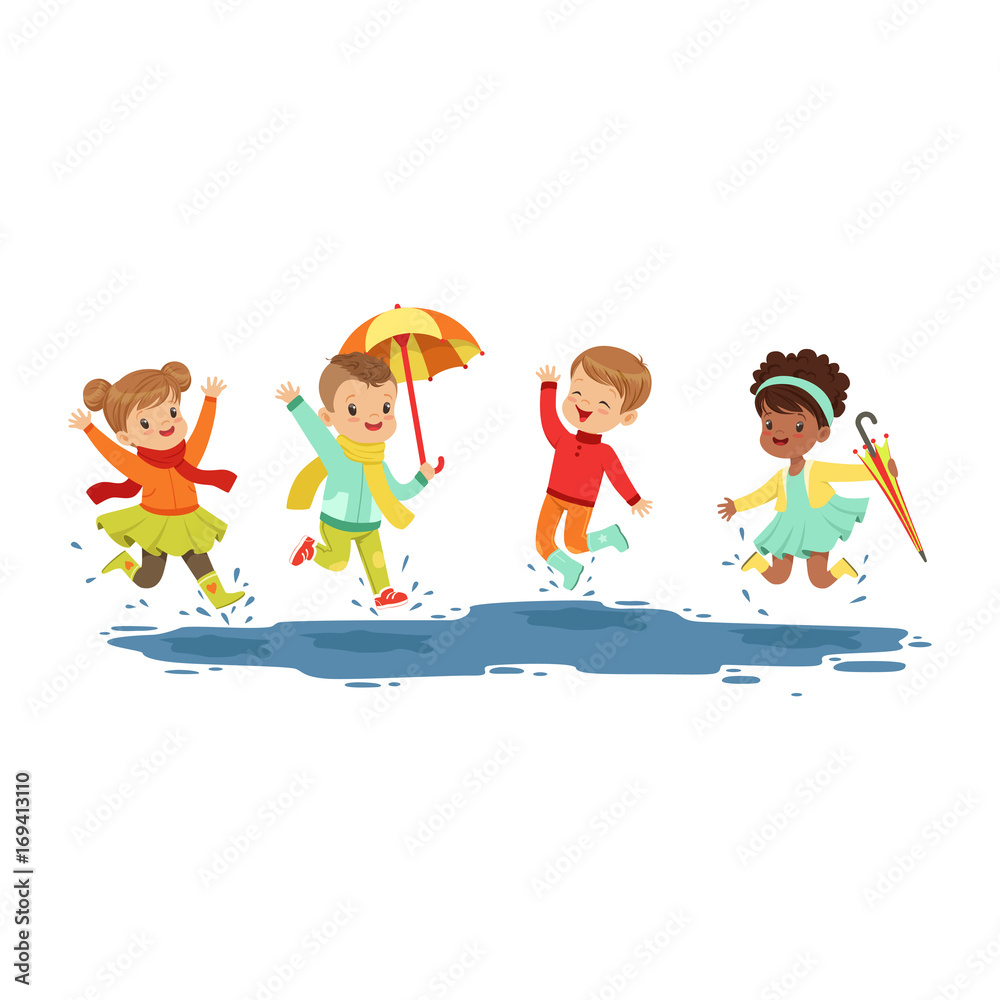 Cute smiling little kids jumping and splashing through the puddles ...