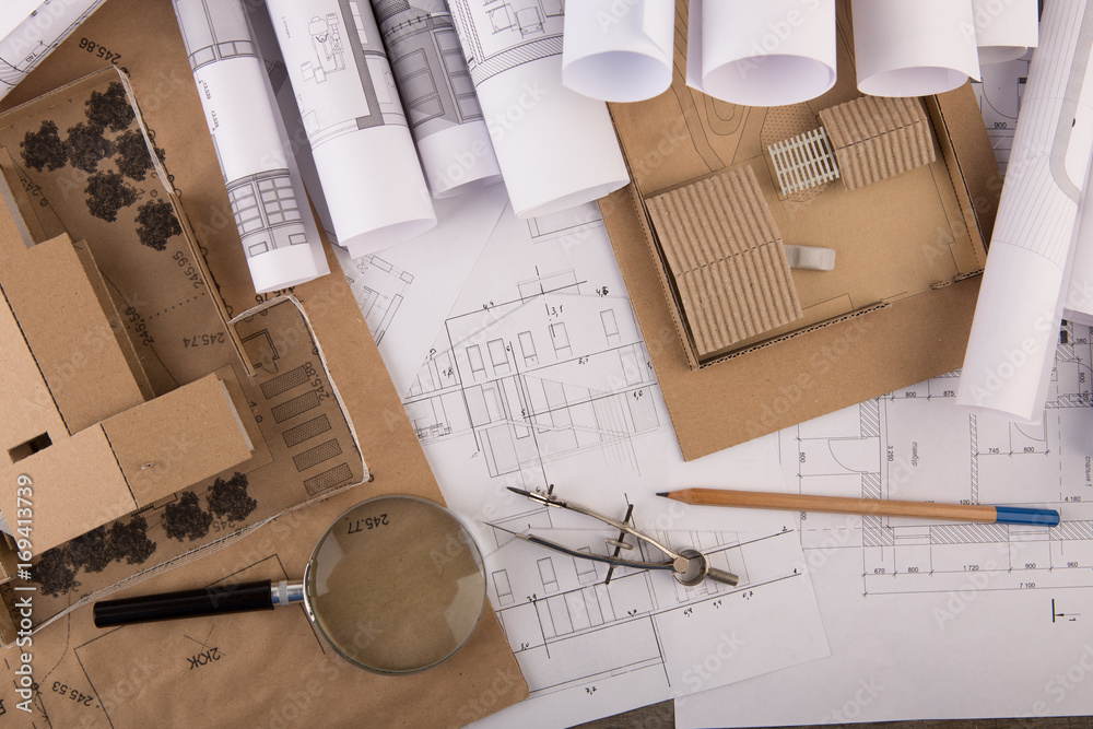 Workplace of architect - construction drawings, scale model and tools ...