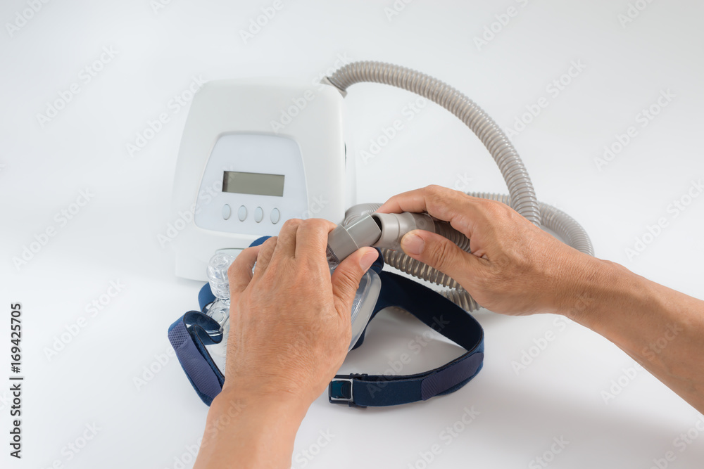 Man hands disassembly patient tube from a nasal mask ,white background ...