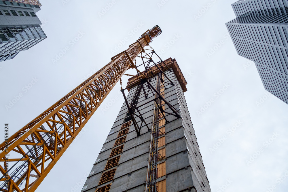 Crane attached to side of building at downtown construction site Stock ...
