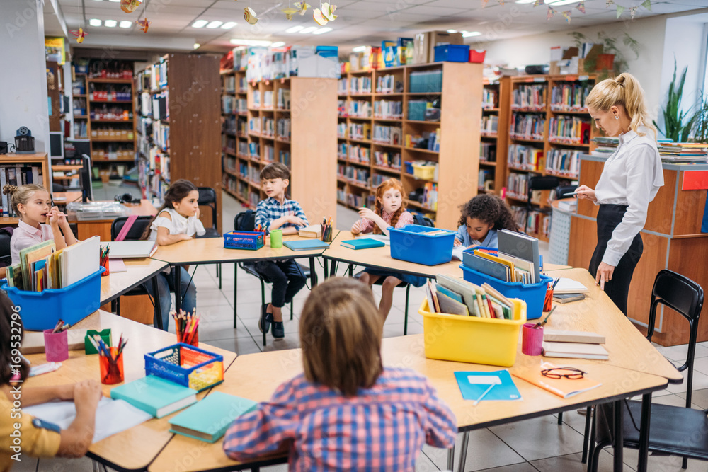 teacher giving lesson in library Stock Photo | Adobe Stock